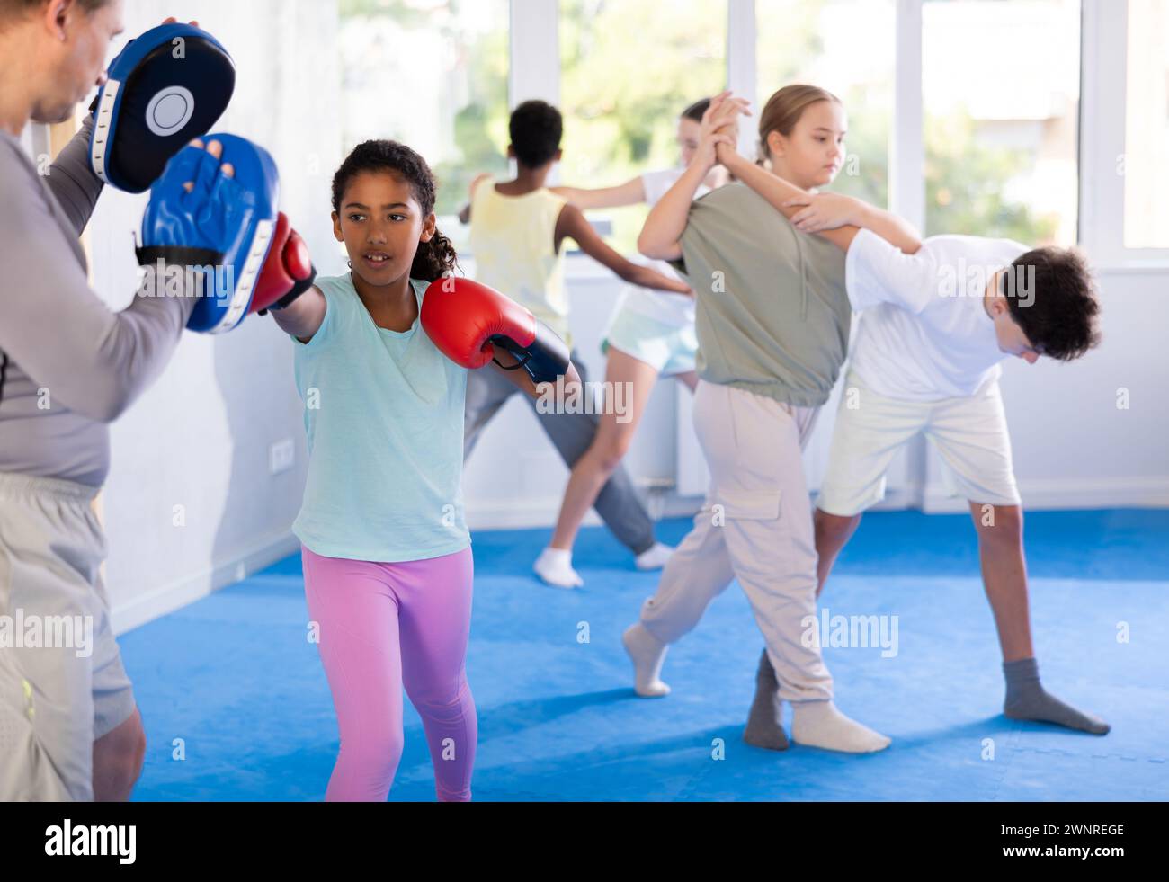 Coach and girl training boxing technique Stock Photo - Alamy