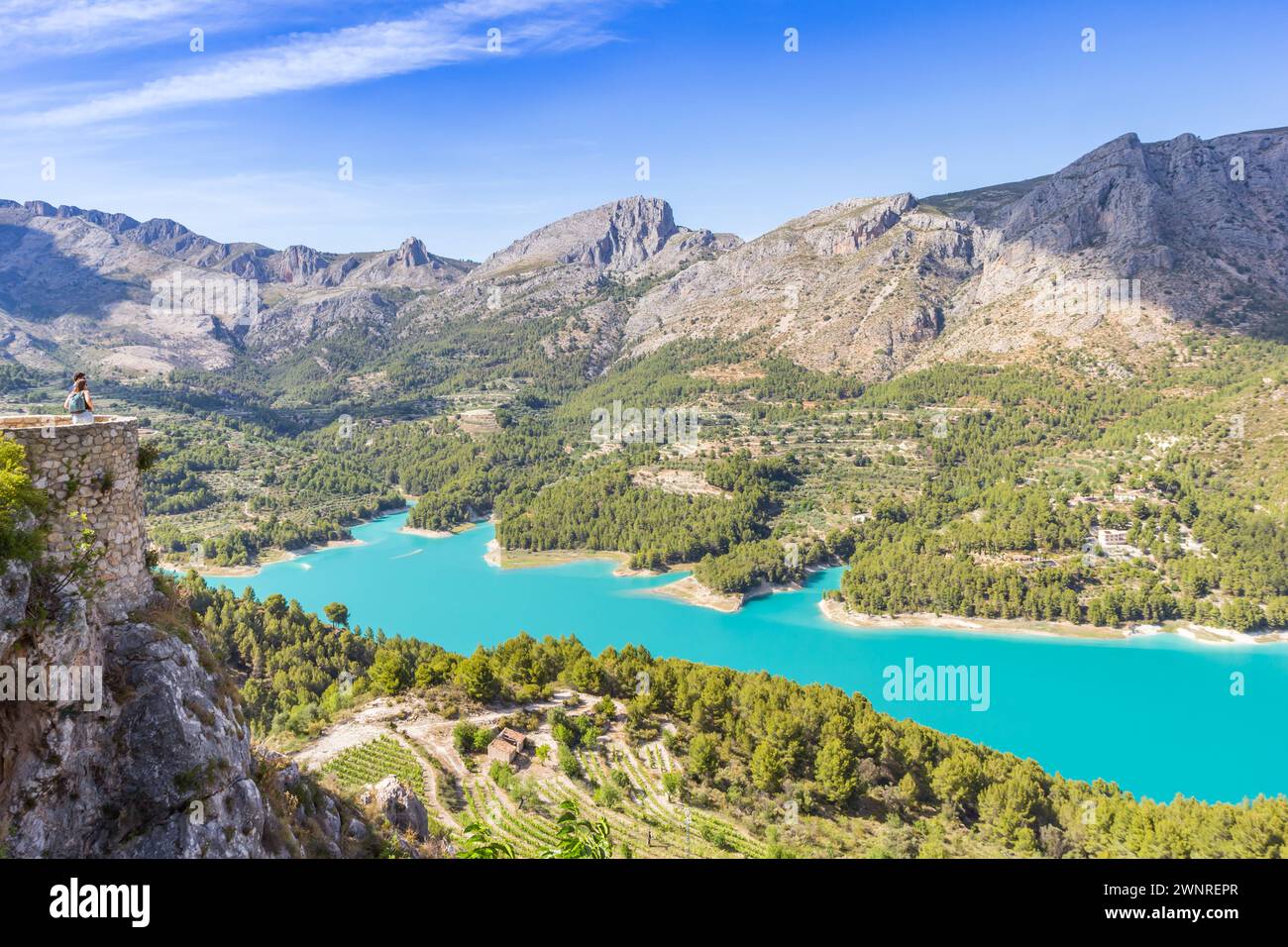 Viewing point at the blue lake of Guadalest, Spain Stock Photo - Alamy