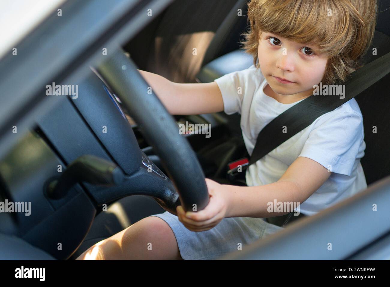 Little Driver. Cute little boy pretending to drive. Kid in car with his ...