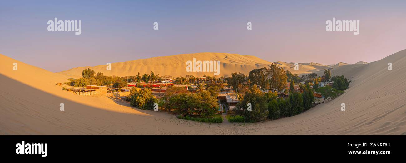 A wide 3:1 panoramic image from a sunrise at the oasis of Huacachina ...