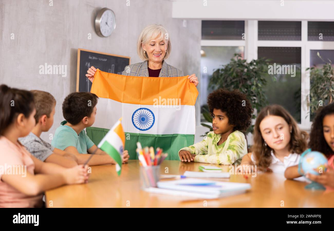 Female teacher showing indian flag to kids in geography class Stock ...