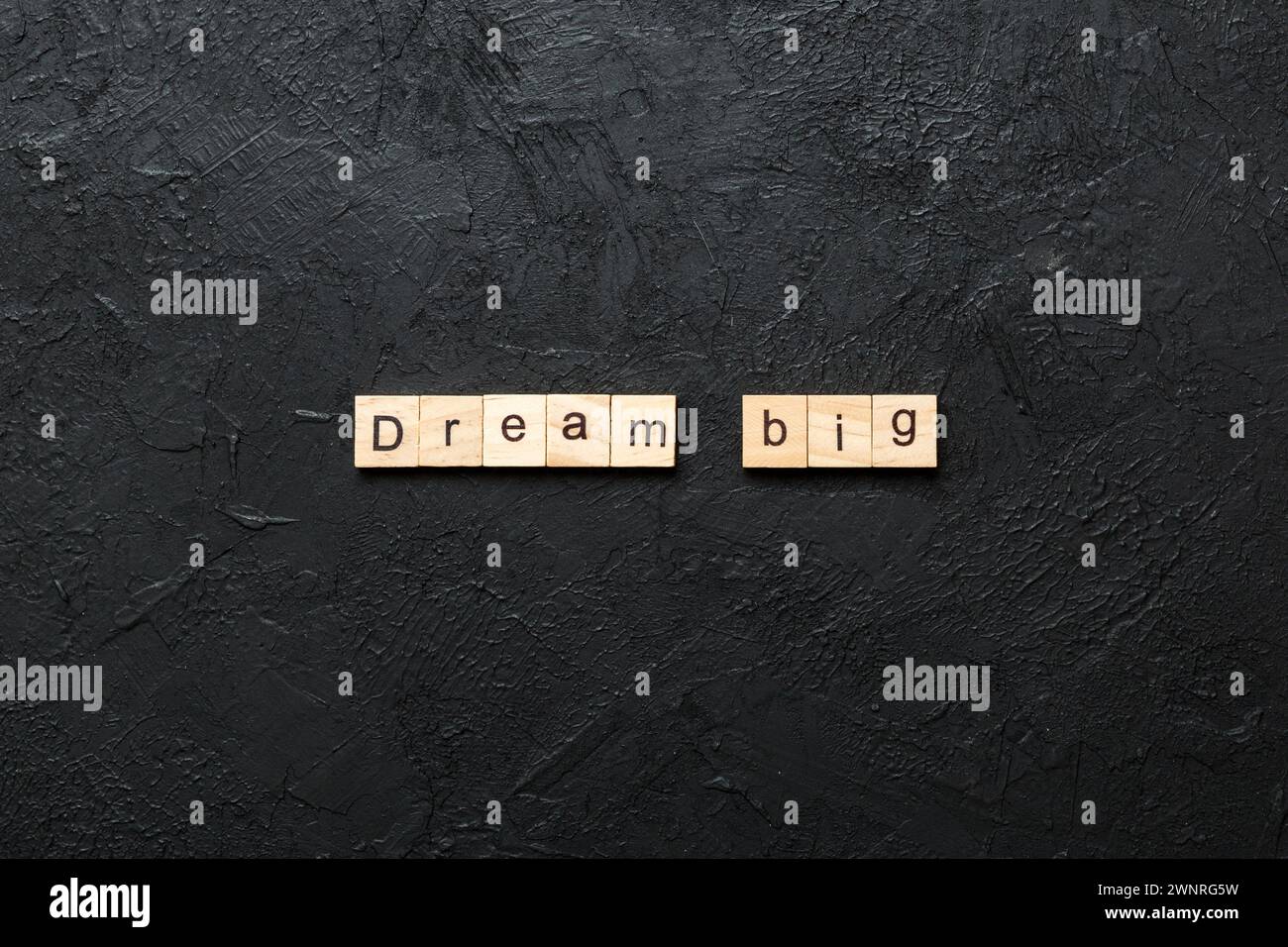 Dream big word written on wood block. Dream big text on cement table for your desing, Top view ...