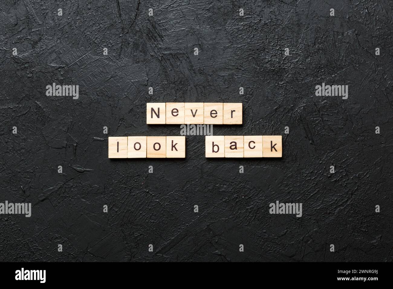 never look back word written on wood block. never look back text on ...