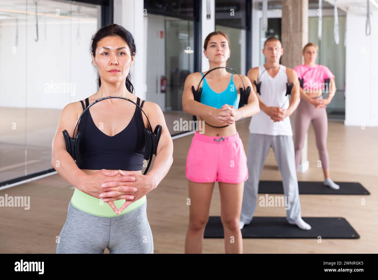 Four people doing exercises with pilates circles Stock Photo - Alamy