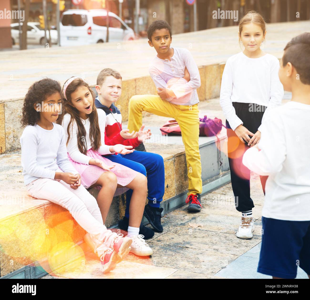 Children during conversation sitting on stairs outdoors Stock Photo - Alamy