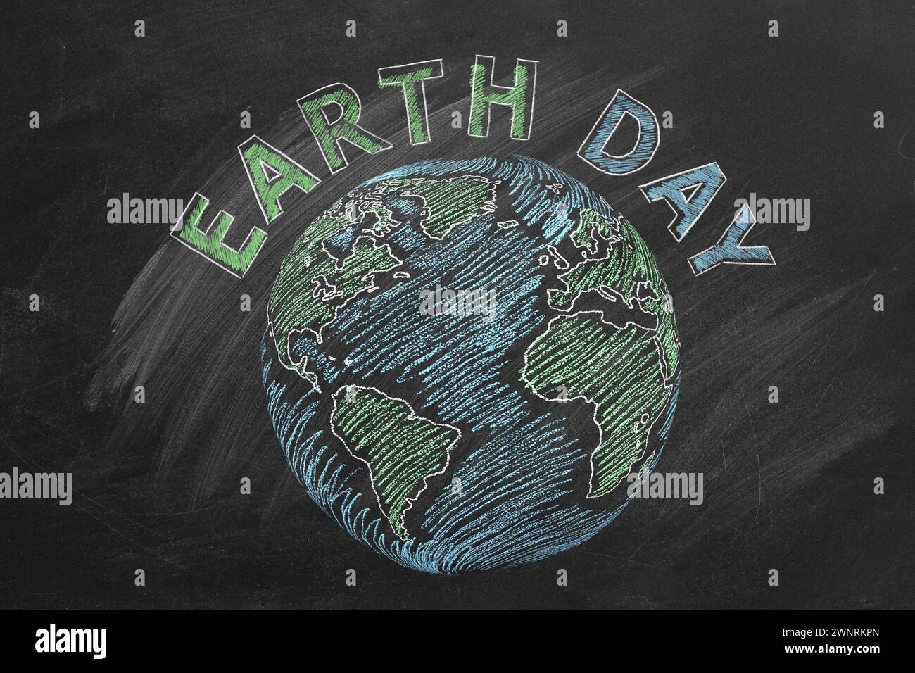 The world with lettering EARTH DAY hand drawn in chalk on a school ...