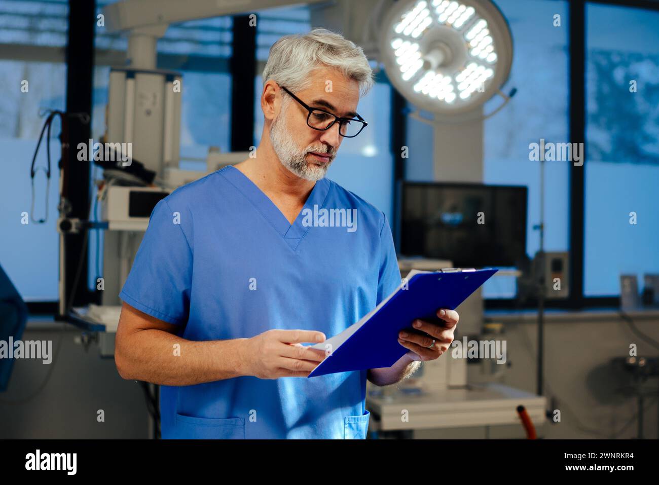 Portrait of confident ER doctor standing in hospital emergency room ...