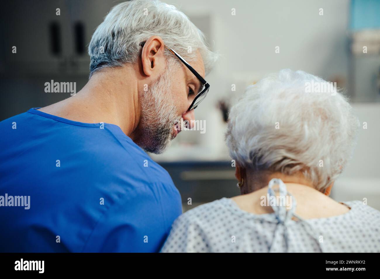 Supportive doctor soothing worried senior patient, discussing test ...