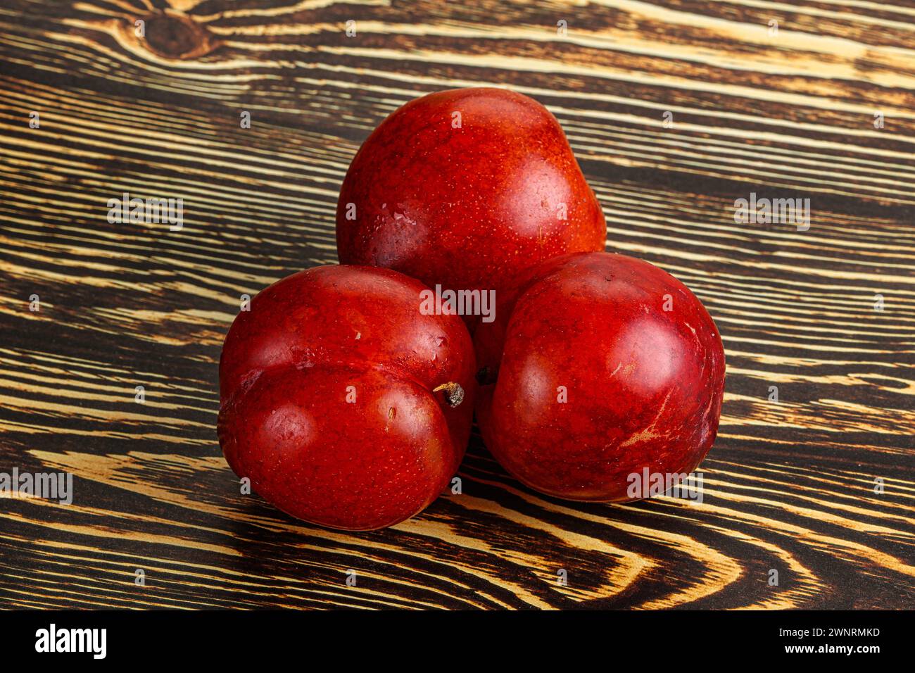 Ripe sweet juicy red plum heap Stock Photo - Alamy