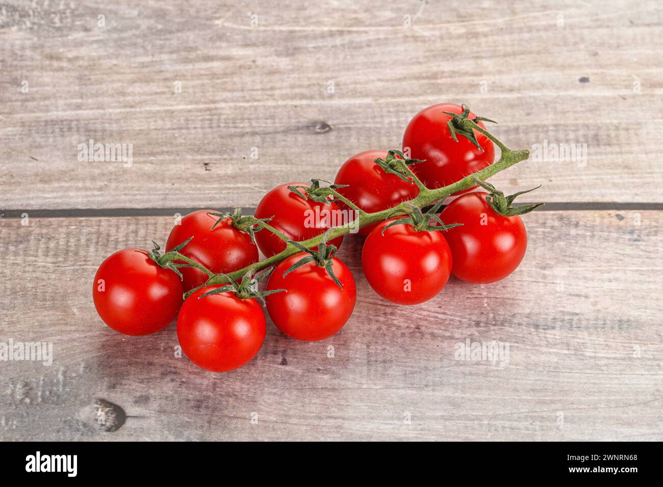 Ripe sweet cherry tomato branch isolated Stock Photo - Alamy