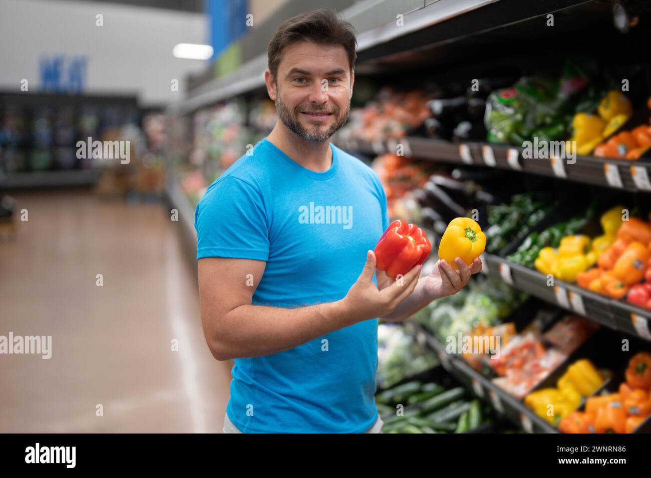 Man with fruits and vegetables at grocery store. Healthy food for mens ...