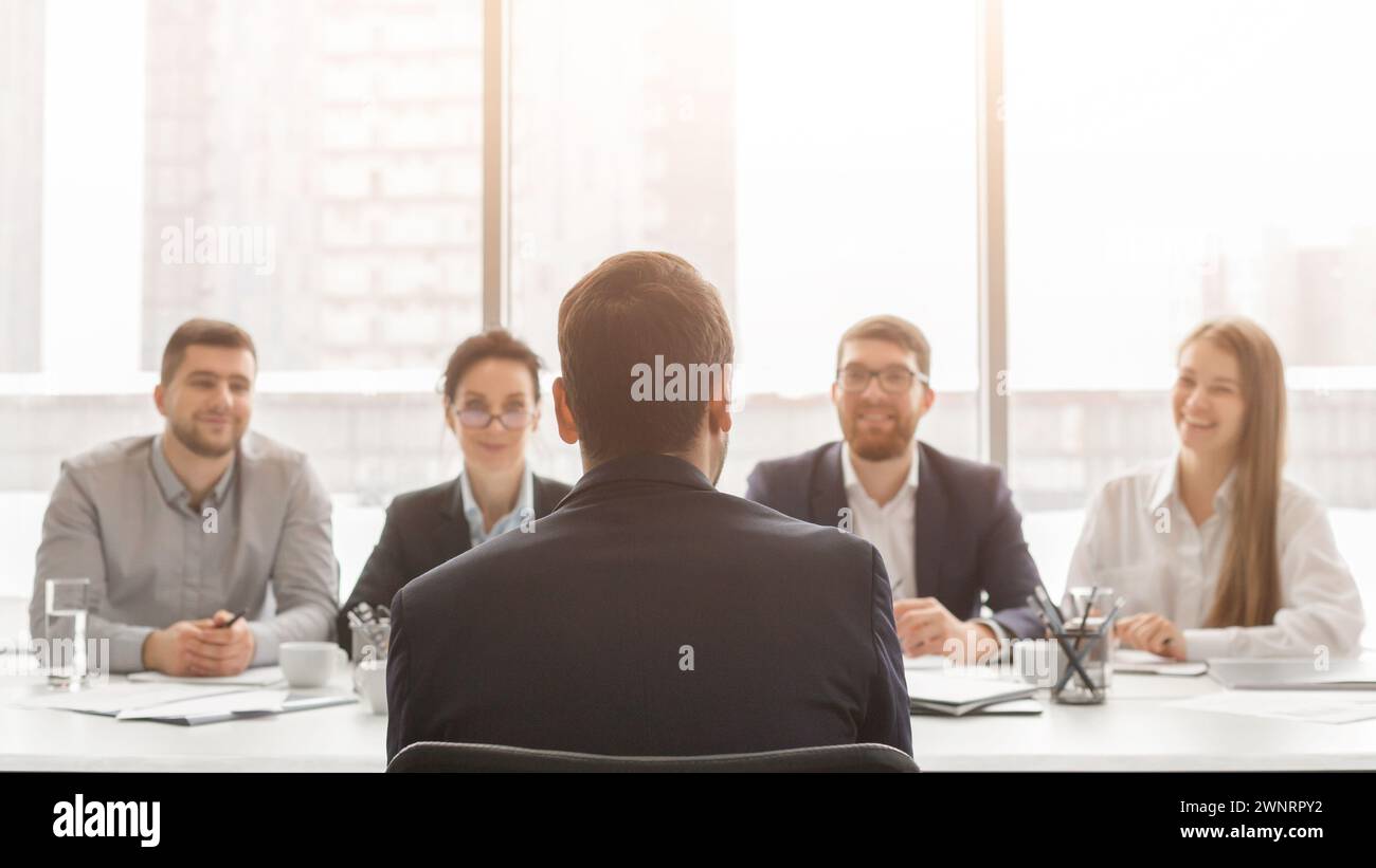Male applicant talking at job interview to hr comission Stock Photo - Alamy