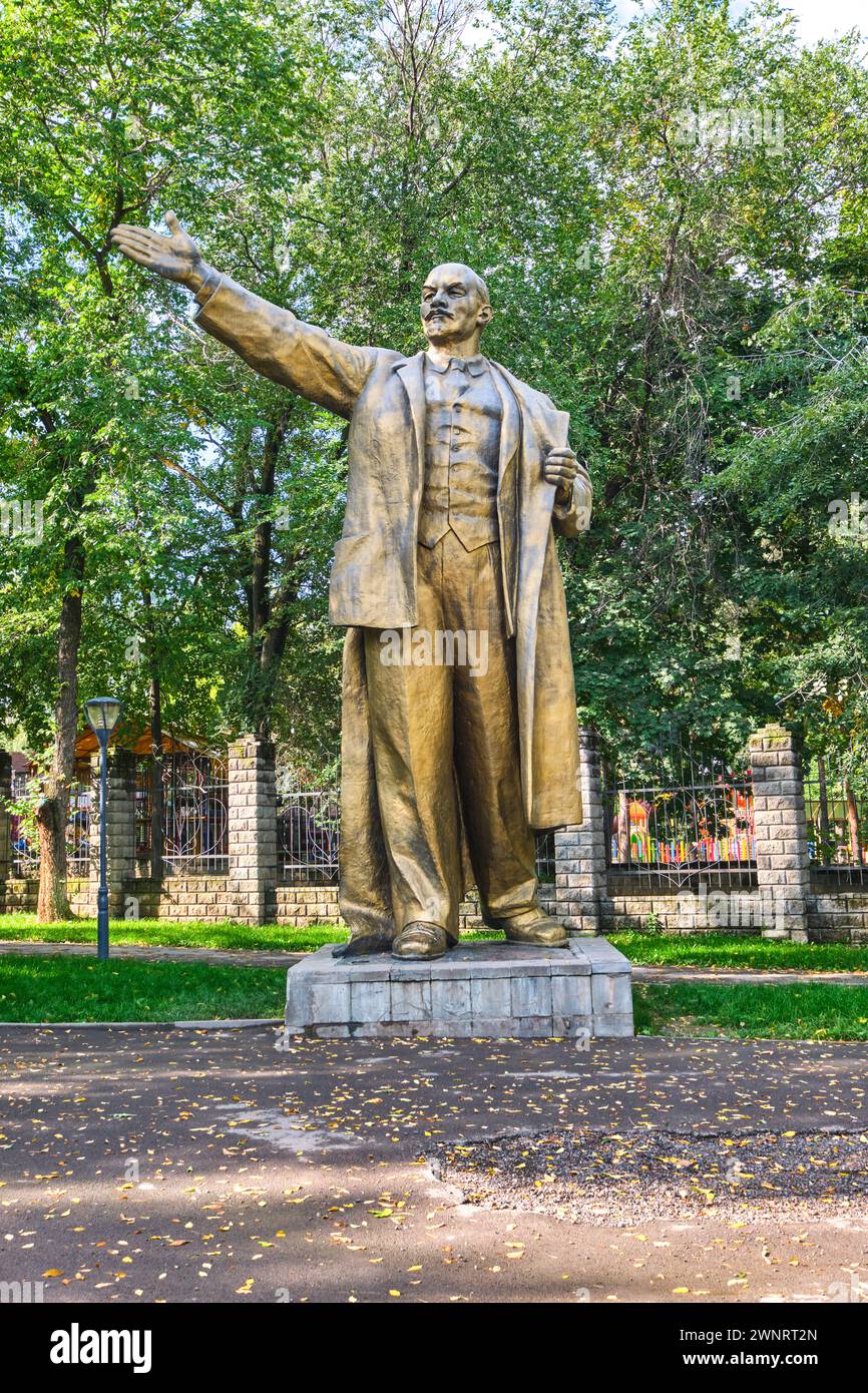 View of the large, gold painted statue of Vladimir Lenin, his right arm ...