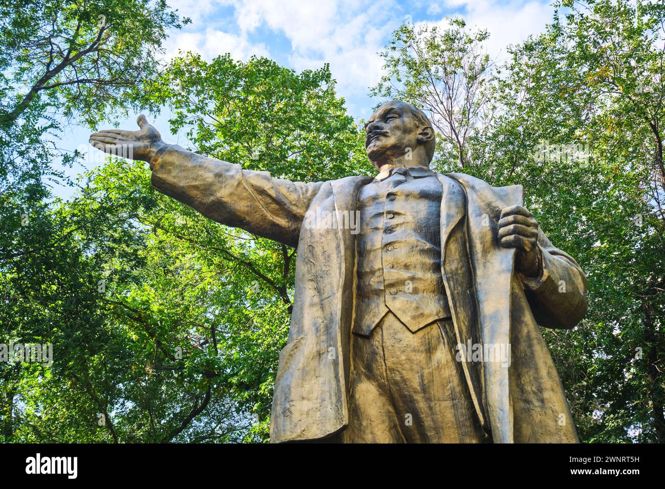 View of the large, gold painted statue of Vladimir Lenin, his right arm ...