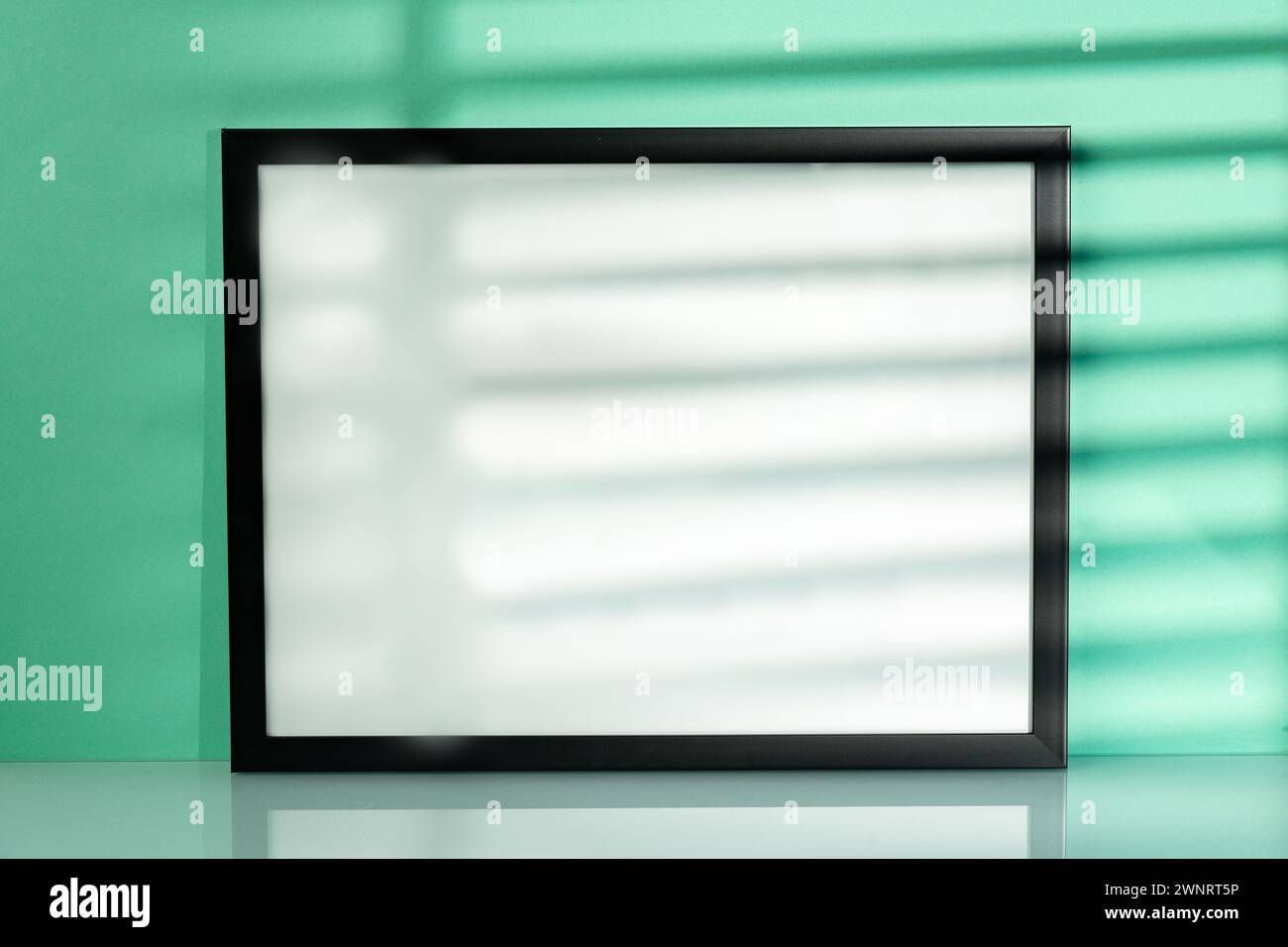 Black frame mock up against mint background with shadow Stock Photo - Alamy