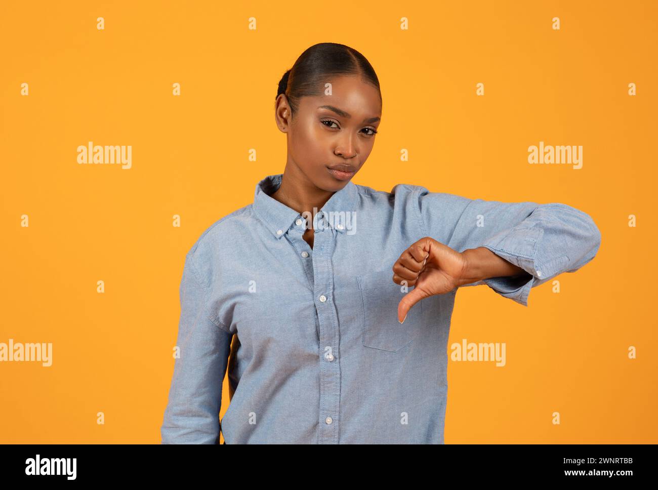 African woman showing thumbs down hi-res stock photography and images ...