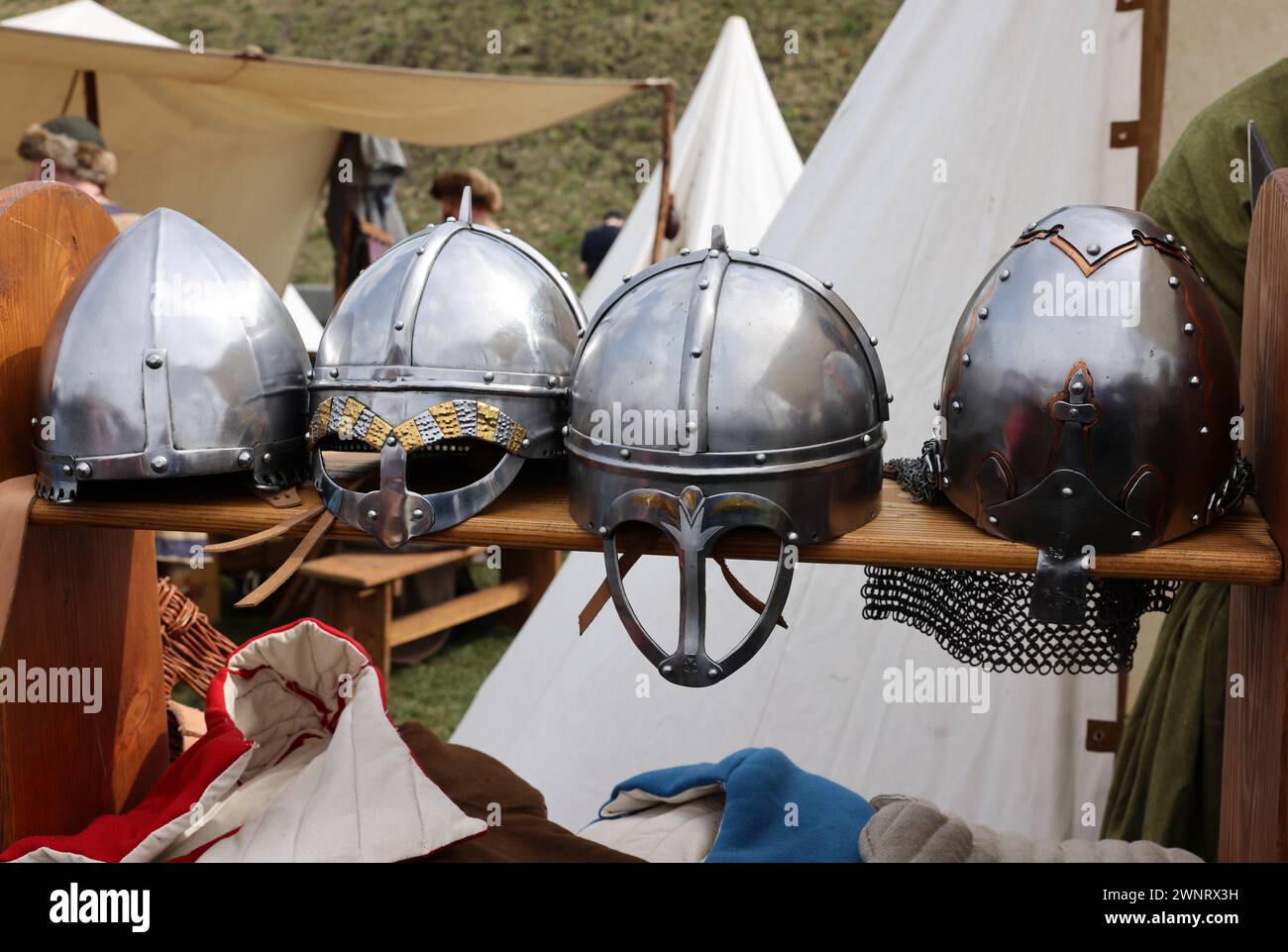 Medieval weapons, helmets in knight camp at the festival of historical ...