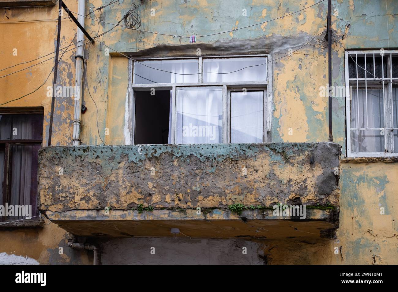 Old residential building with balcony. Simple people living. Scuffed ...