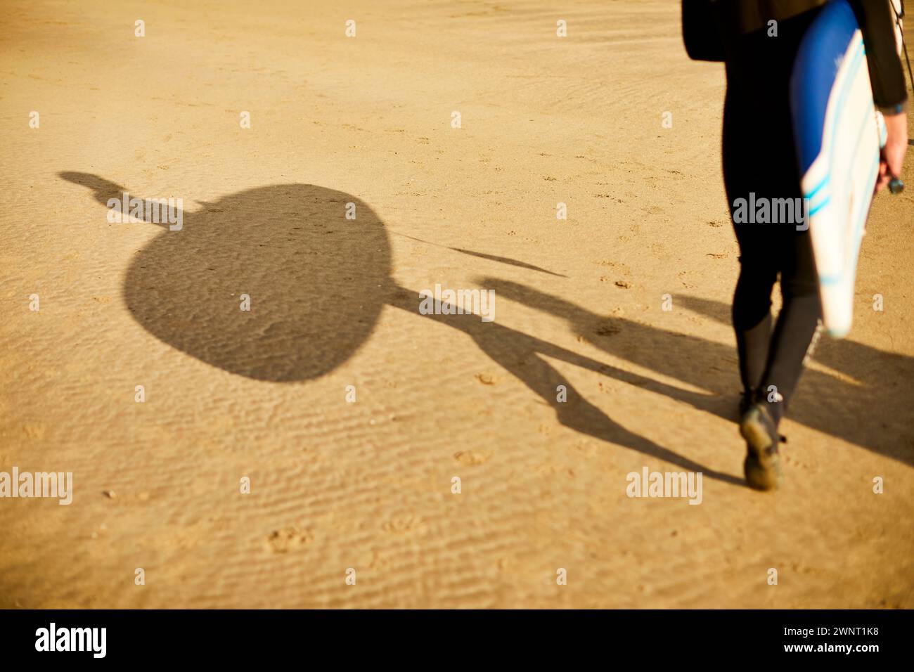 Shadow Of A Surfer Carrying His Surfboard At Beach Stock Photo - Alamy