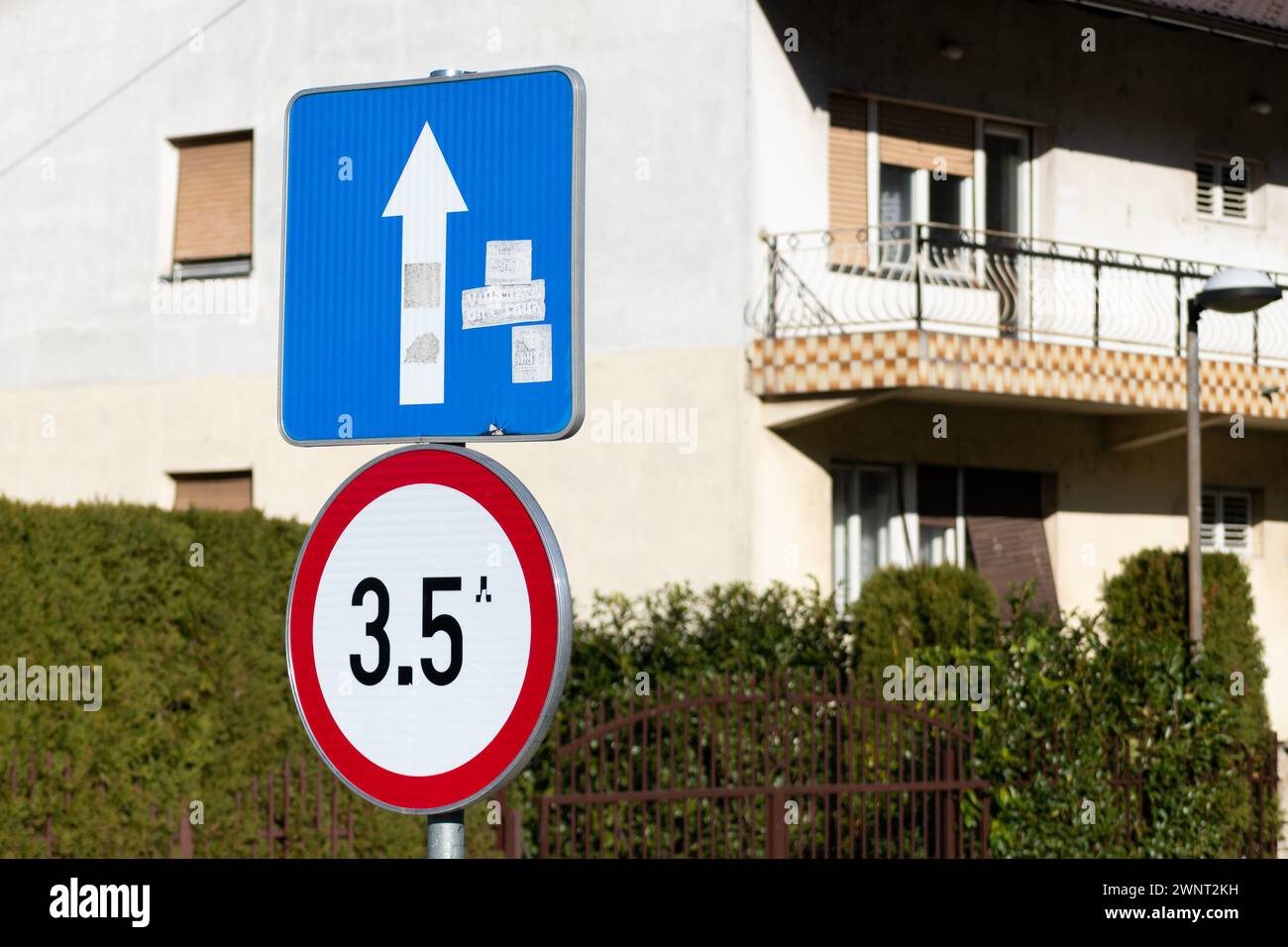 Damaged traffic signs with stickers, maximum gross weight and one way ...