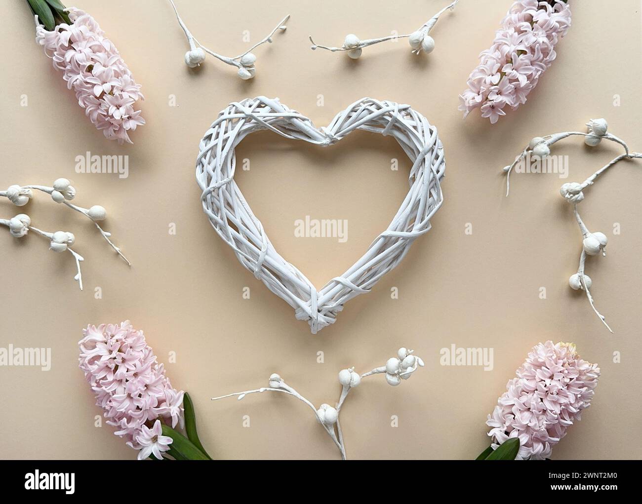 A heart-shaped object crafted from wicker material, adorned with pink ...