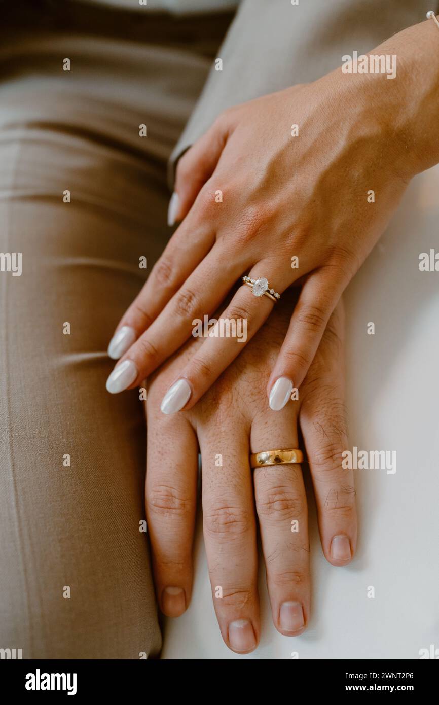 Married couple showing off wedding rings Stock Photo - Alamy