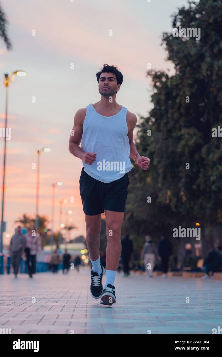 Handsome man running in sunset hi-res stock photography and images - Alamy