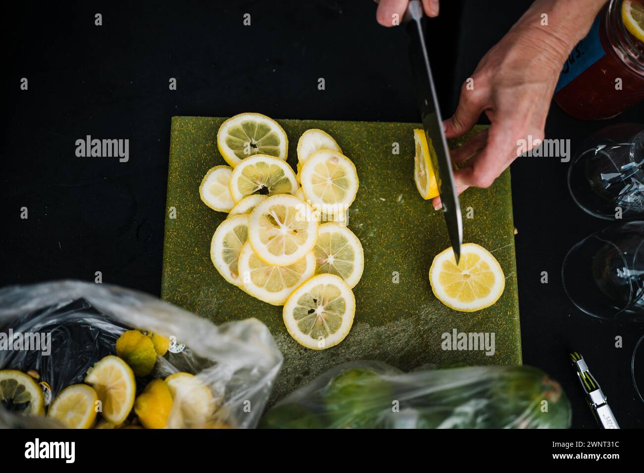 Chef cutting lemons on cutting board Stock Photo - Alamy