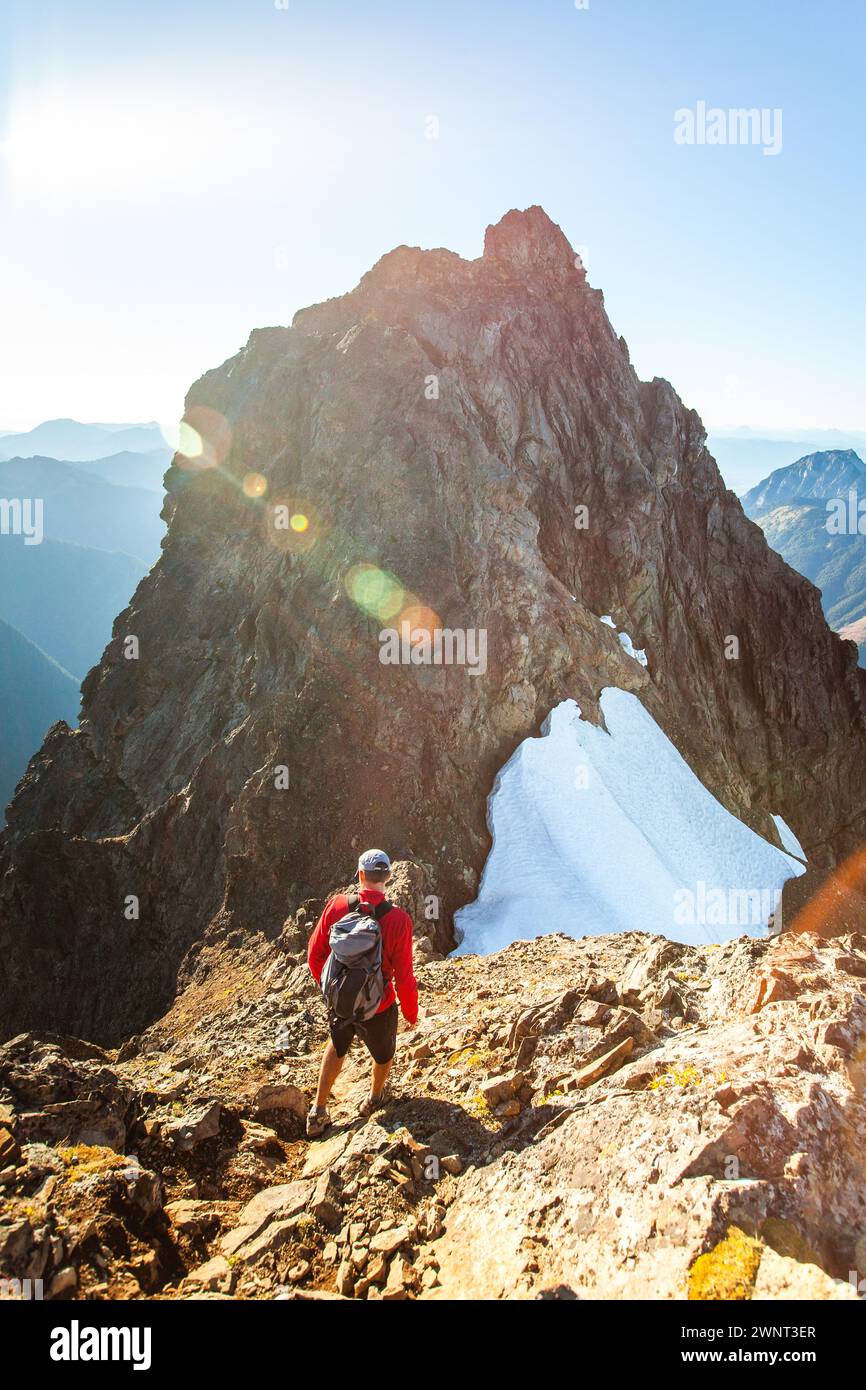 Rear view of climber approaching a mountain summit Stock Photo - Alamy