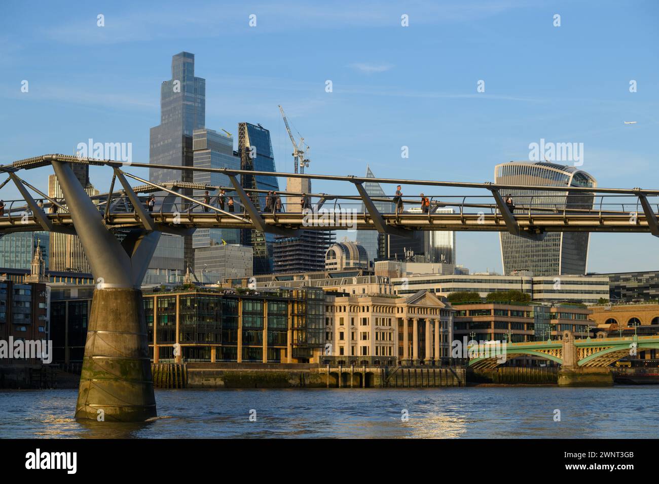 The Millennium footbridge over the River Thames with the skyscrapers of ...