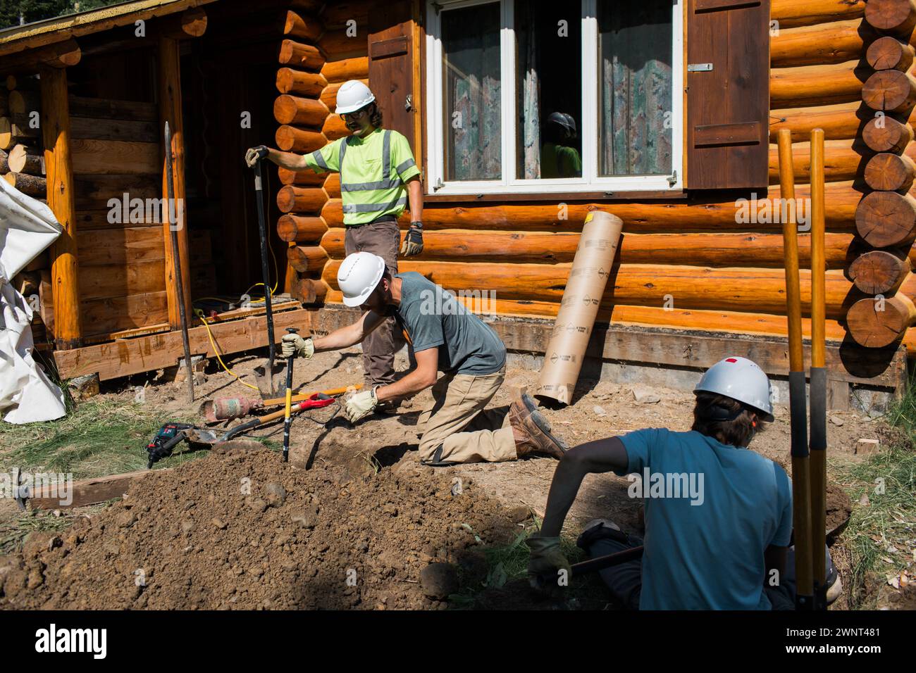 Construction crew actively renovating cabin Stock Photo - Alamy
