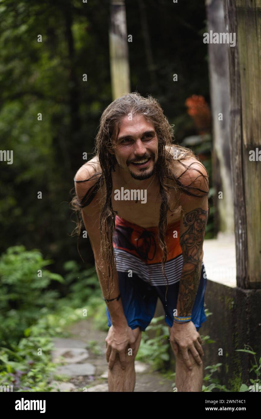 Man jumps from a cliff into the Alin-Alin waterfall. Bali Stock Photo ...