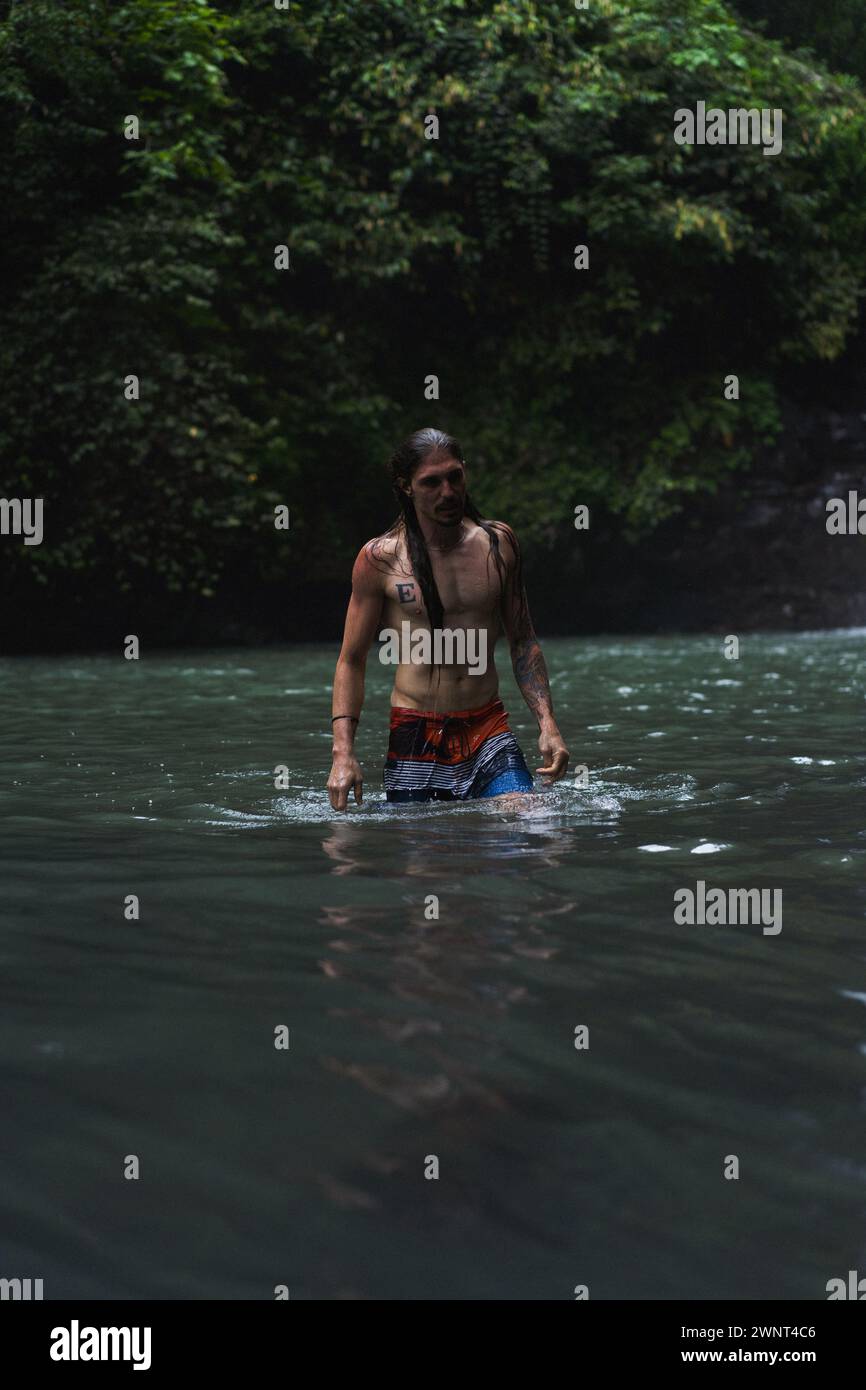 Young handsome man comes out of the water. Bali Stock Photo - Alamy