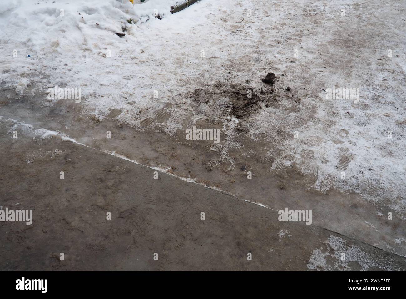 Snow, ice, slush and winter mud at a pedestrian crossing. The air ...