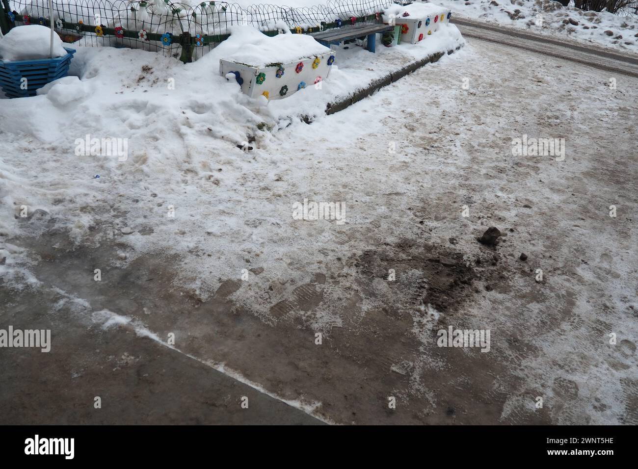 Snow, ice, slush and winter mud at a pedestrian crossing. The air ...