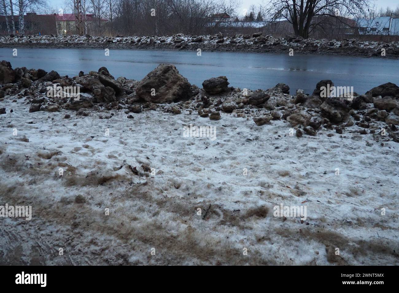 Snow, ice, slush and winter mud at a pedestrian crossing. The air ...
