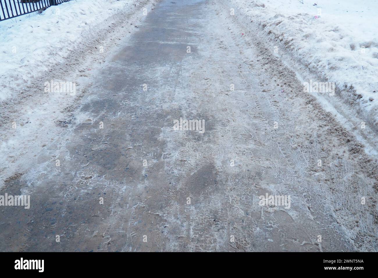 Snow, ice, slush and winter mud at a pedestrian crossing. The air ...