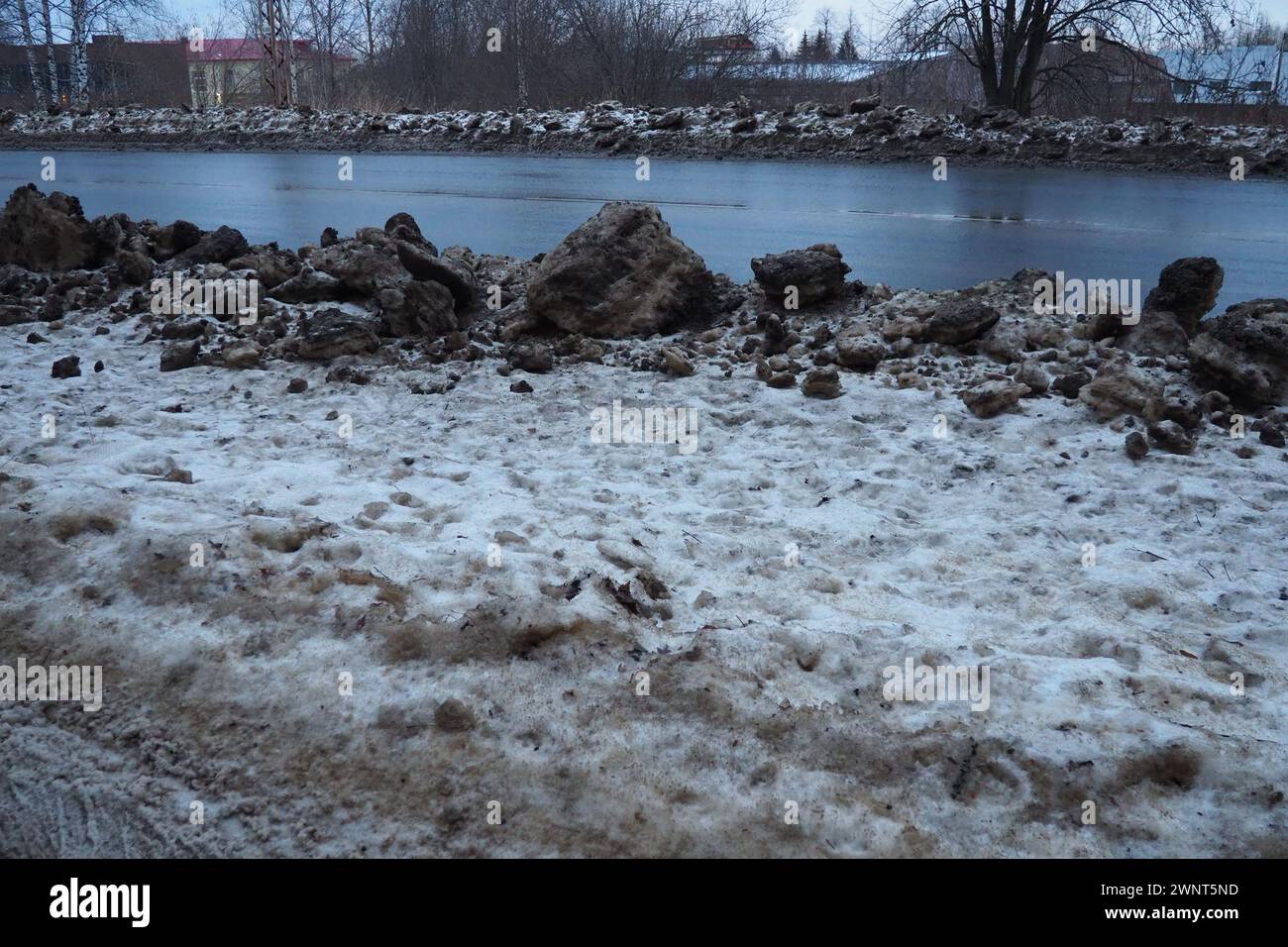 Snow, ice, slush and winter mud at a pedestrian crossing. The air ...
