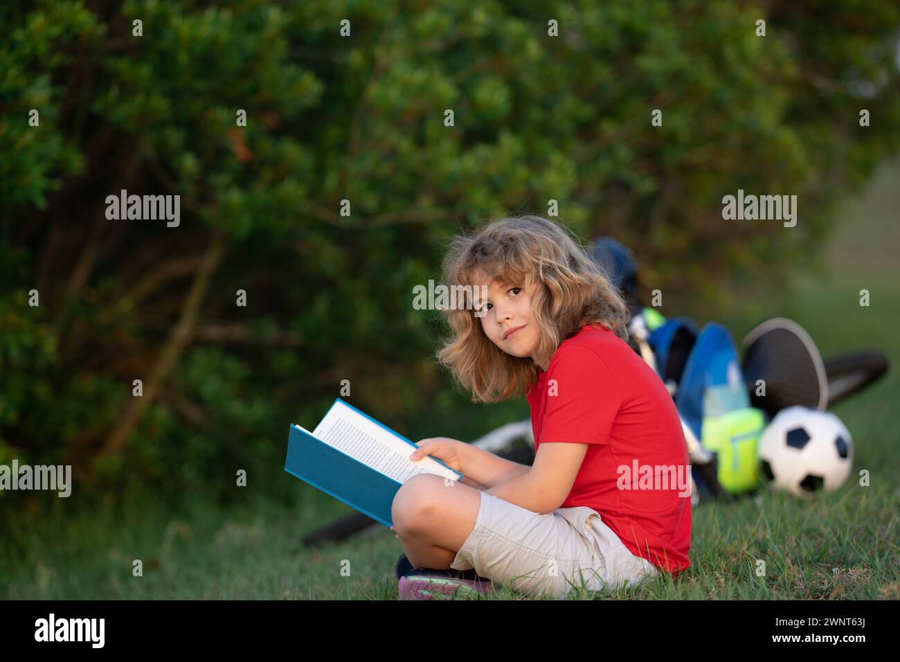 Child read a book. Elementary outdoor school. Early education for ...