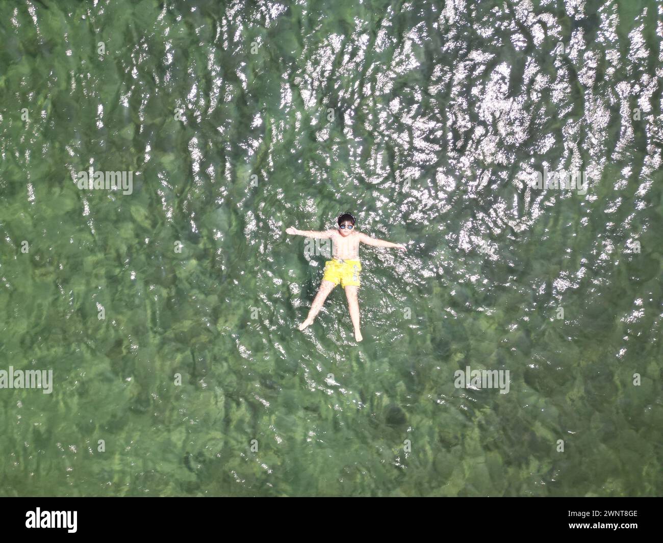 Aerial view of person floating on water in natural landscape Stock ...