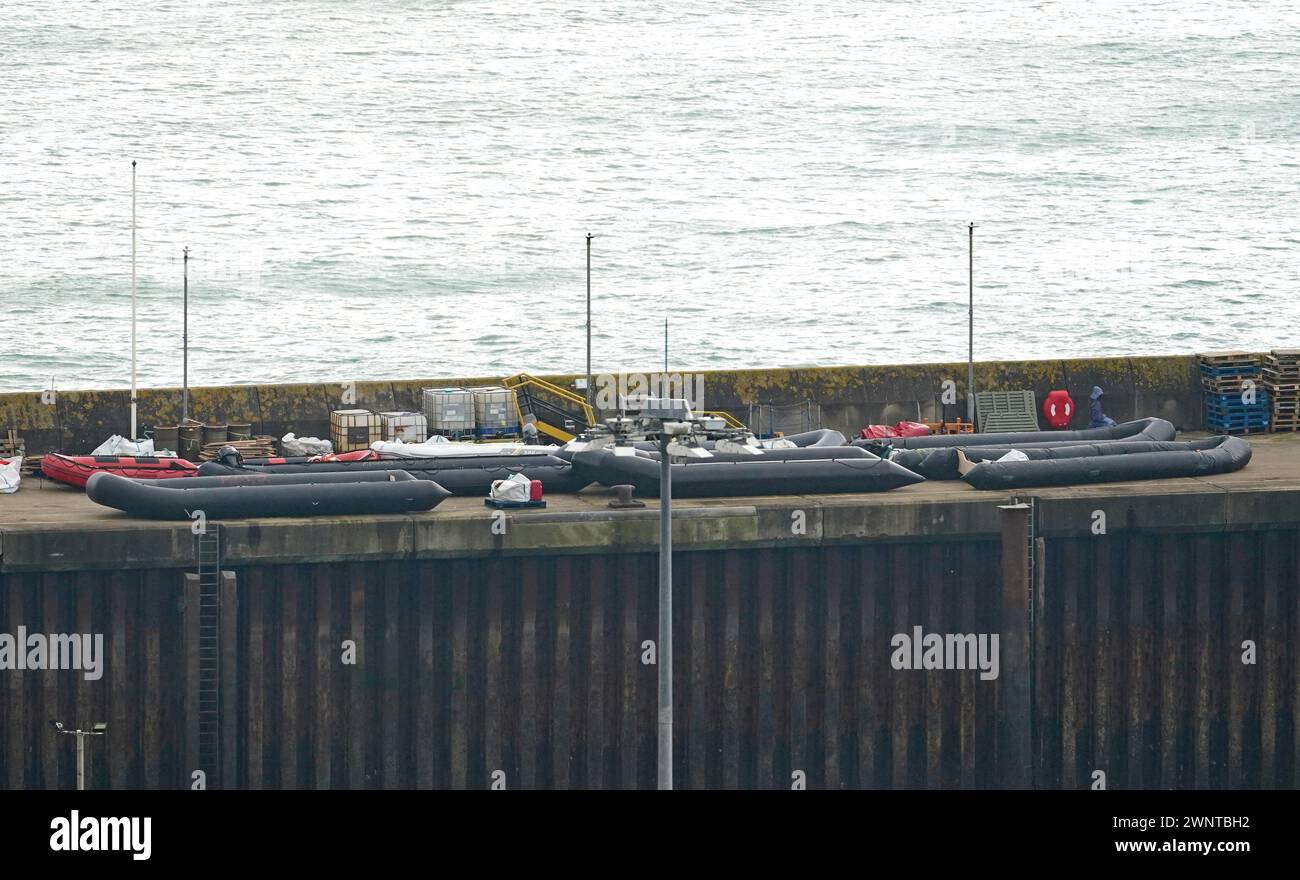 Boats used in previous crossings on the quayside after group of people ...