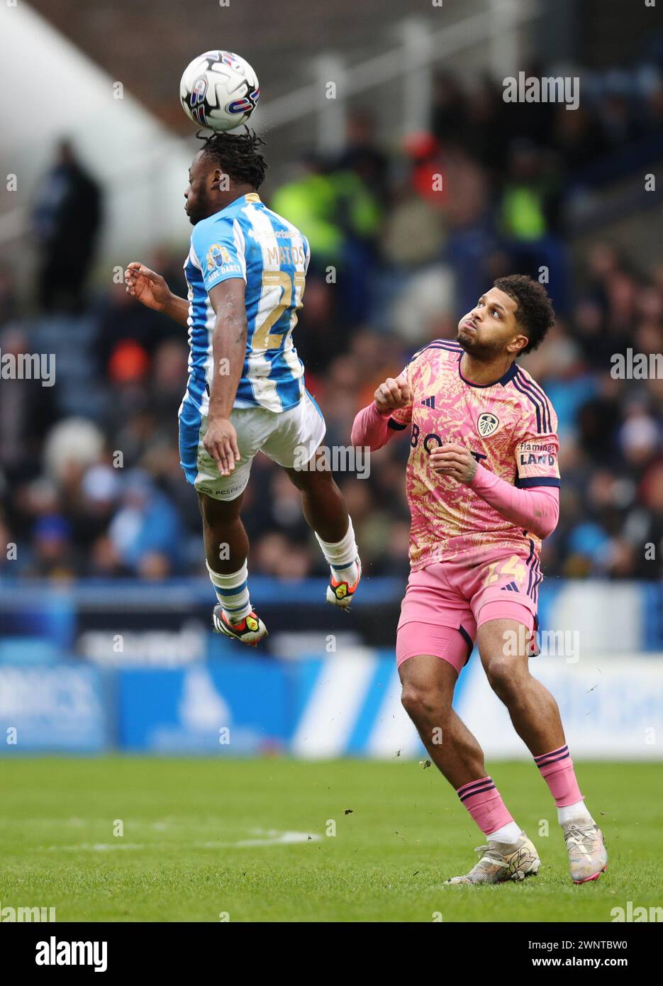 Huddersfield Town's Alex Matos (left) wins a header whilst under ...