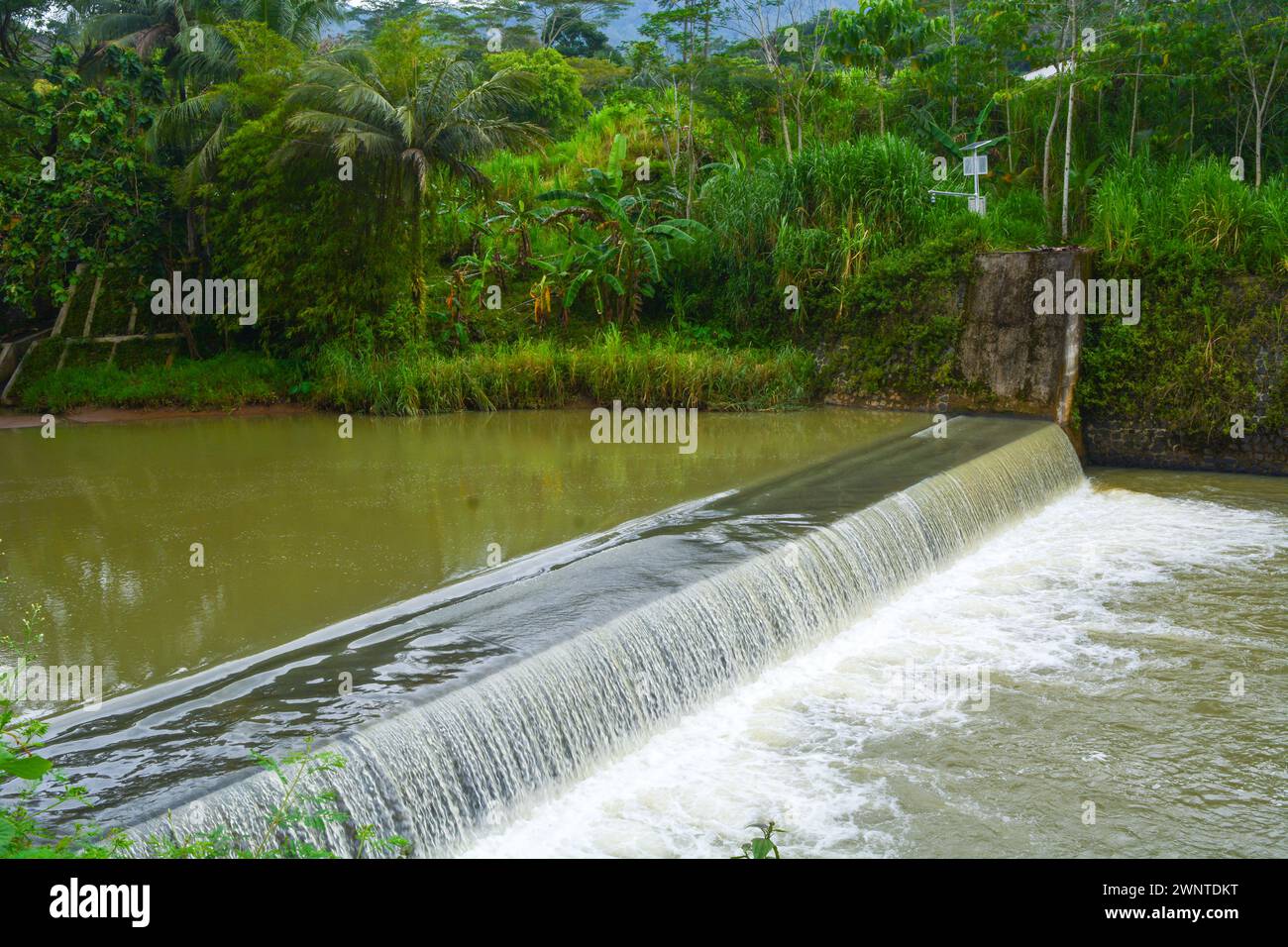 A fast-flowing stream and dramatic lenticular clouds against a dark sky ...