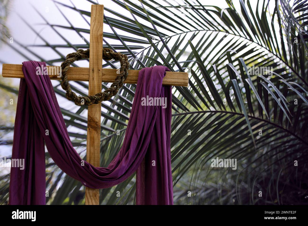 wooden cross with crown of thorns and purple fabric, catholic symbols ...