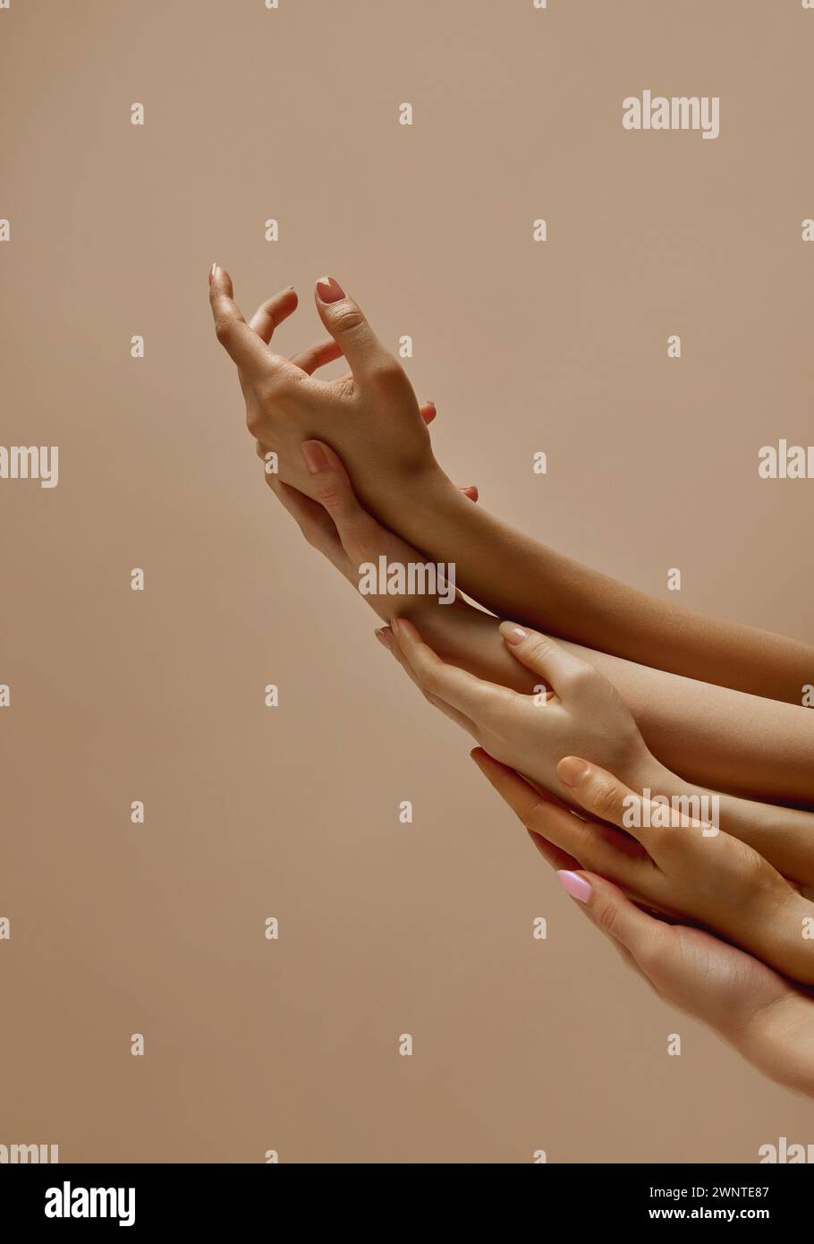 Female well-groomed hands lying on each other showcasing support ...