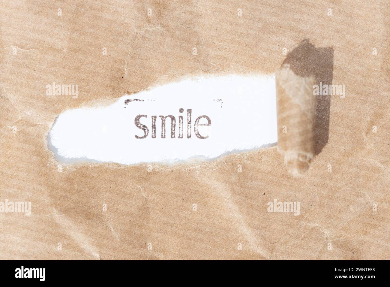 Smile message. Brown paper torn stripe with text on white paper ...