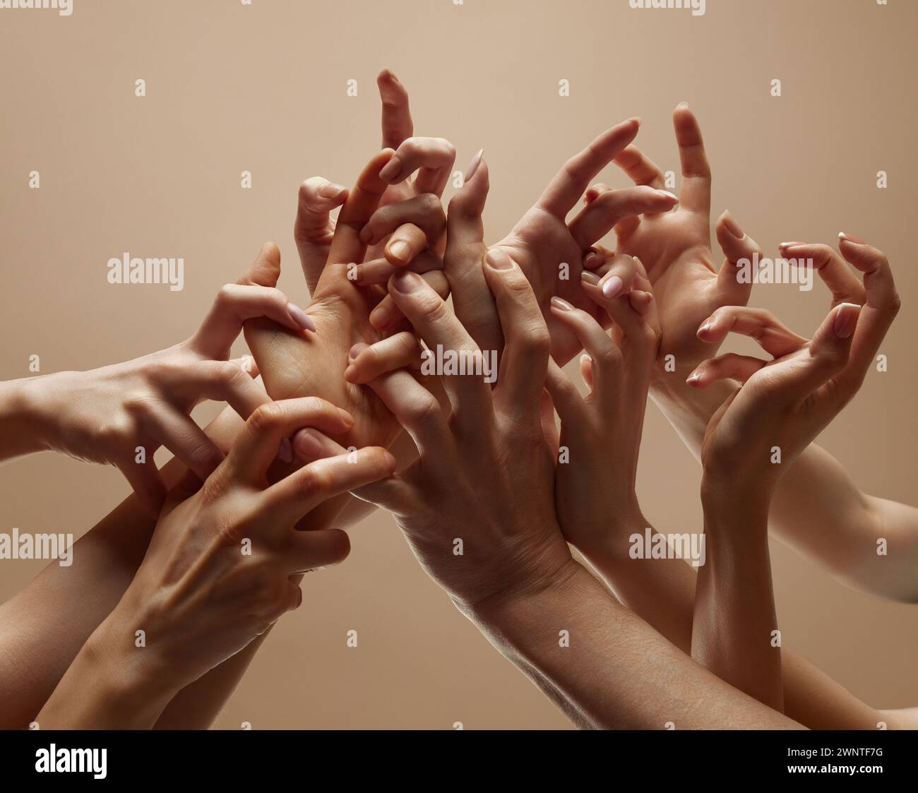 Multiple intertwined hands from various angles creating unity against ...