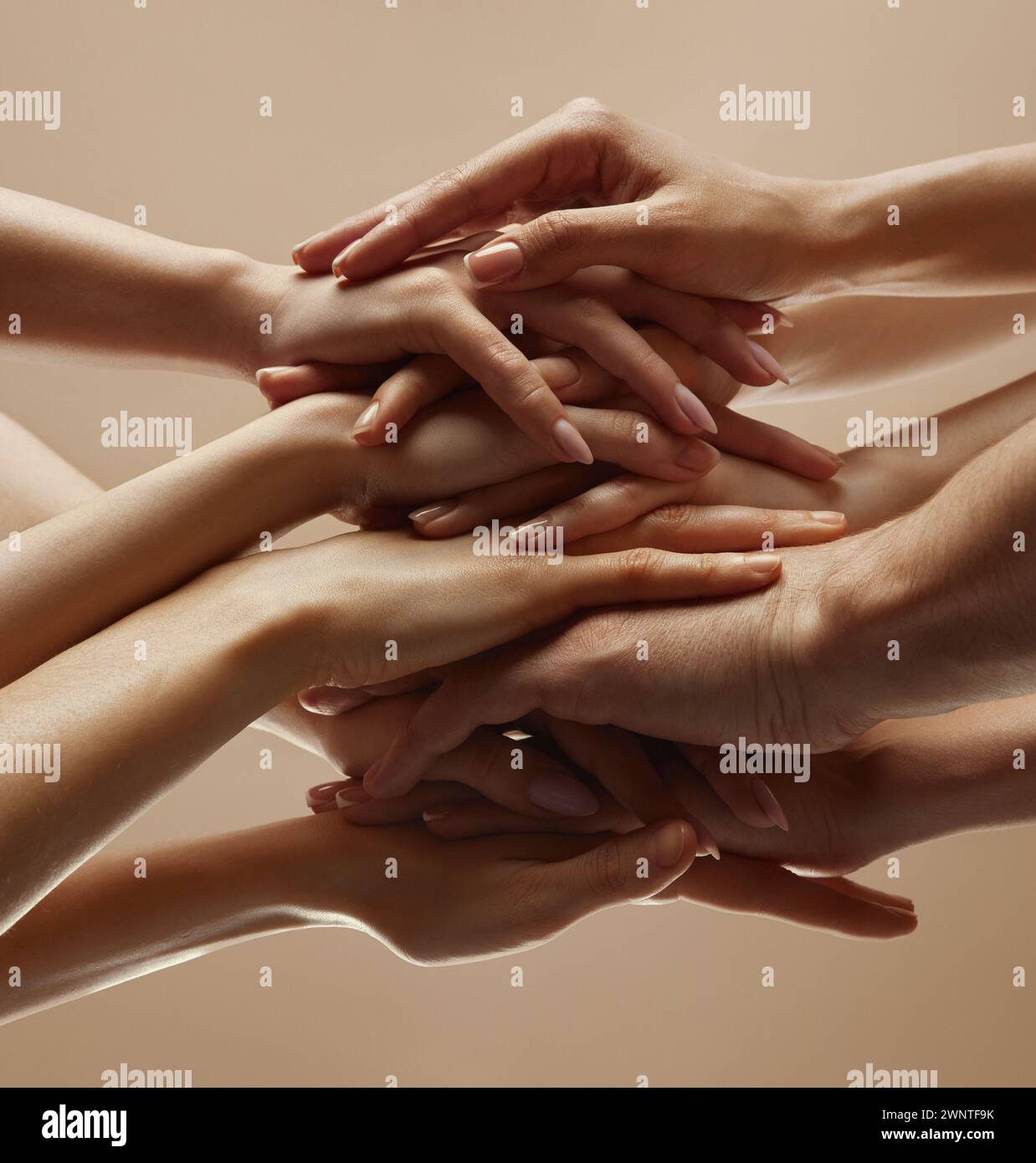 Various woman puts his hands together showcasing unity, teamwork and ...