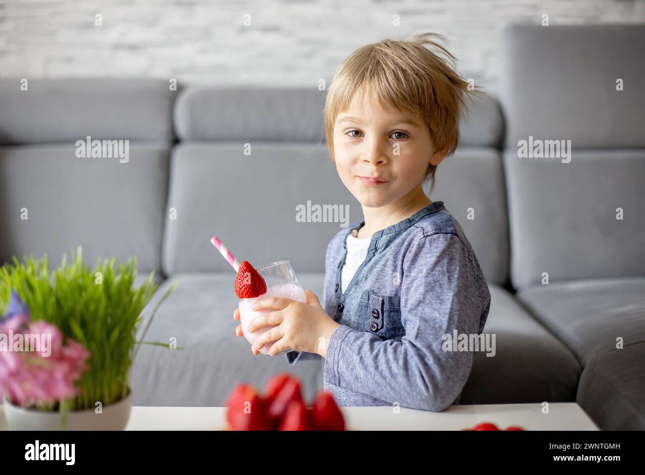 Sweet preschool child, boy, eating belgian waffle with strawberries and ...