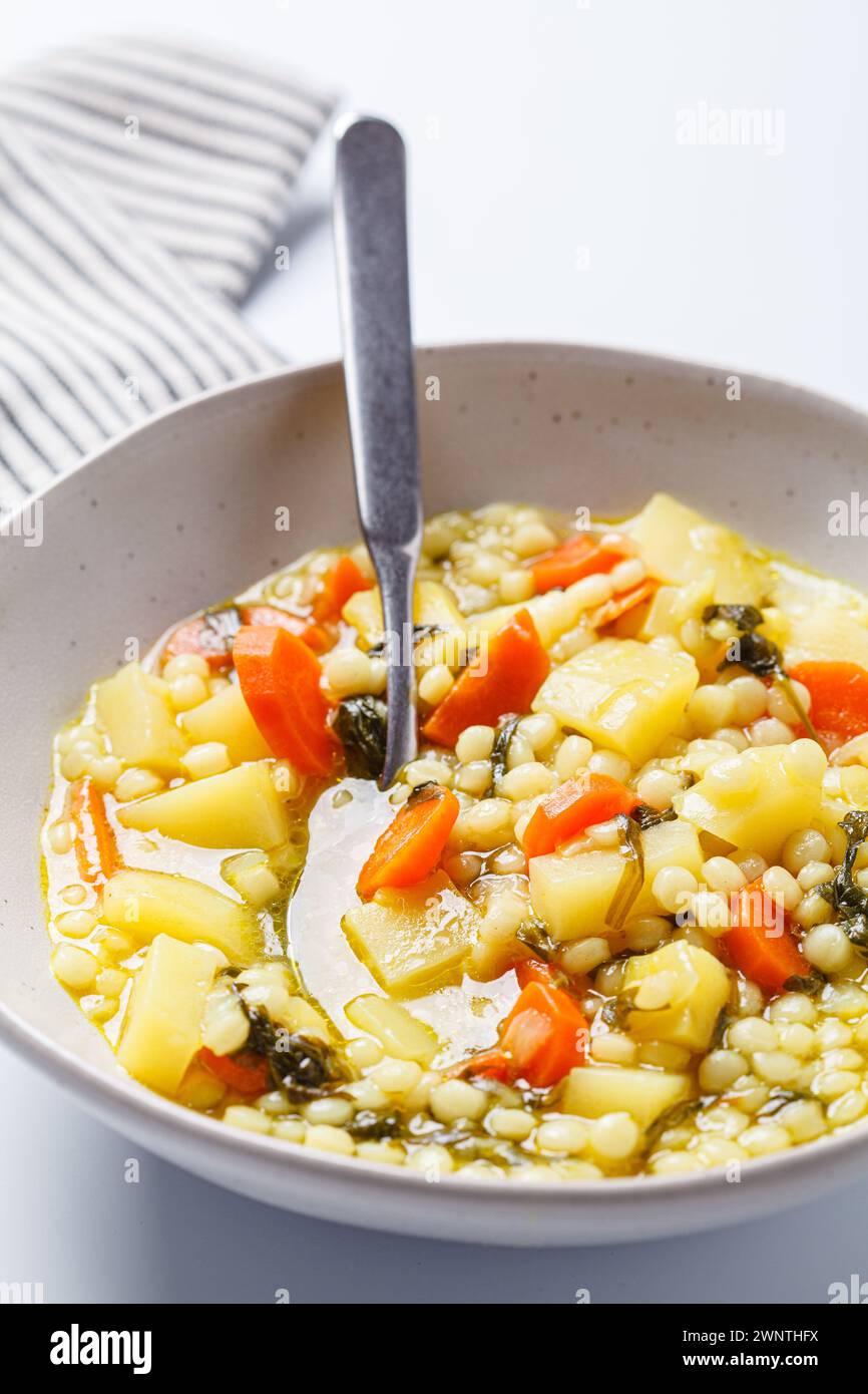 Traditional Israeli soup with ptitim, vegetables and spinach Stock ...